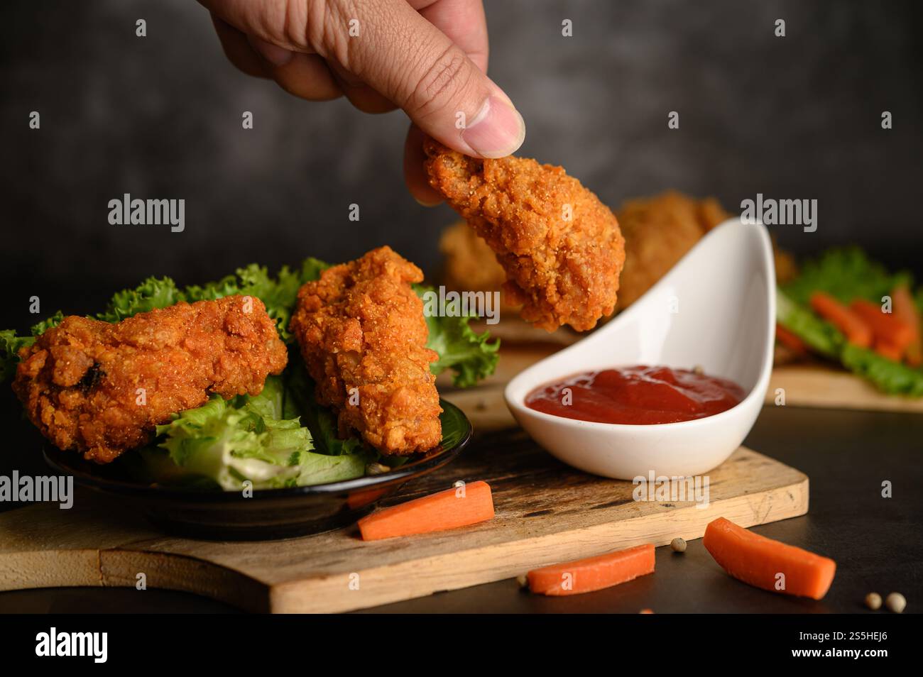 Hand holding crispy fried chicken. Selective focus Stock Photo - Alamy