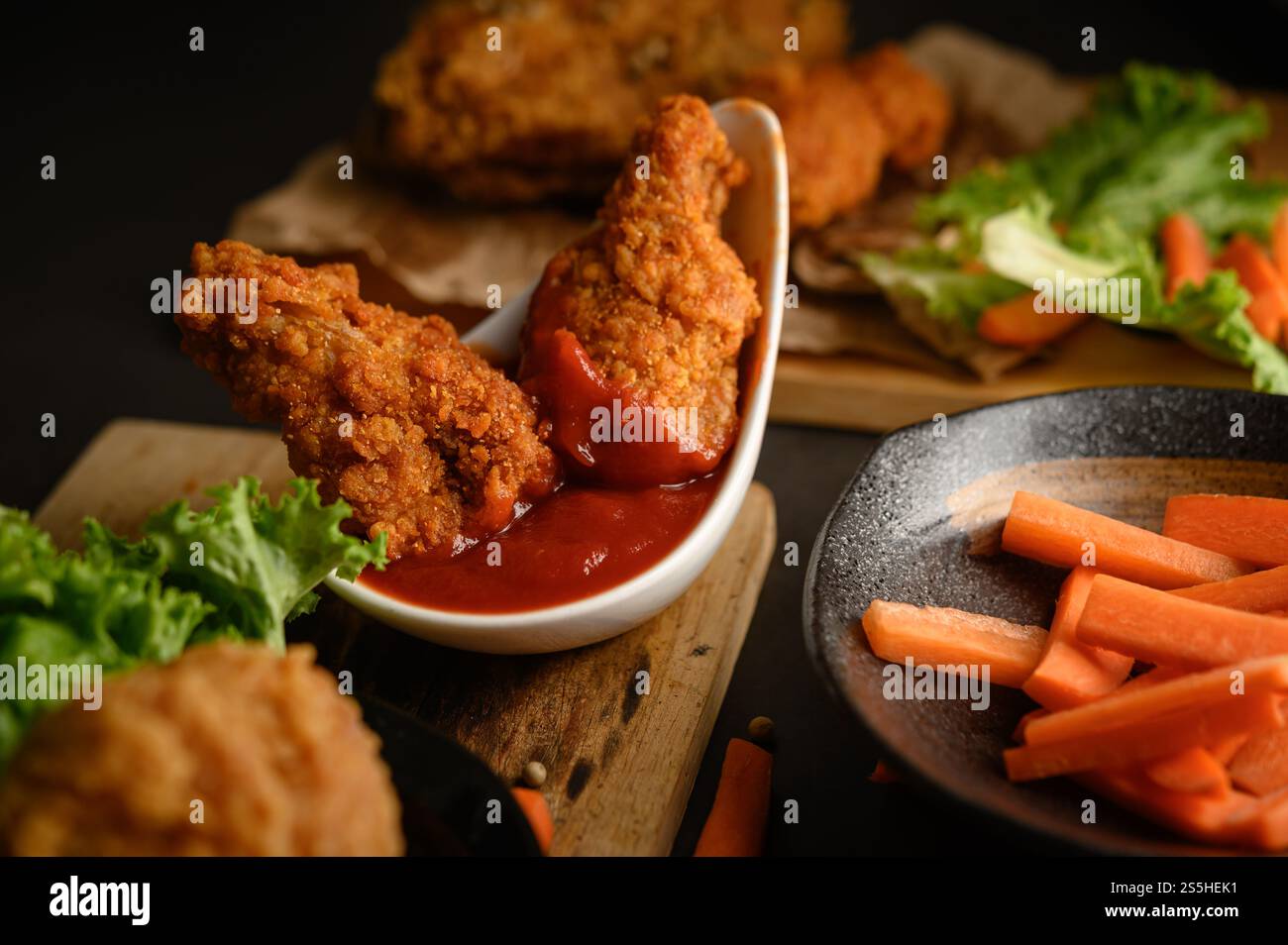 crispy fried chicken dipped in tomato sauce. Selective focus Stock ...