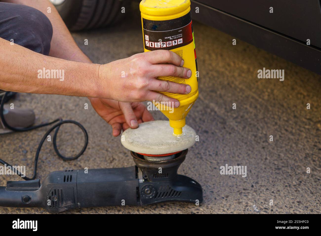 A professional person, with only his arm visible, empties the contents ...