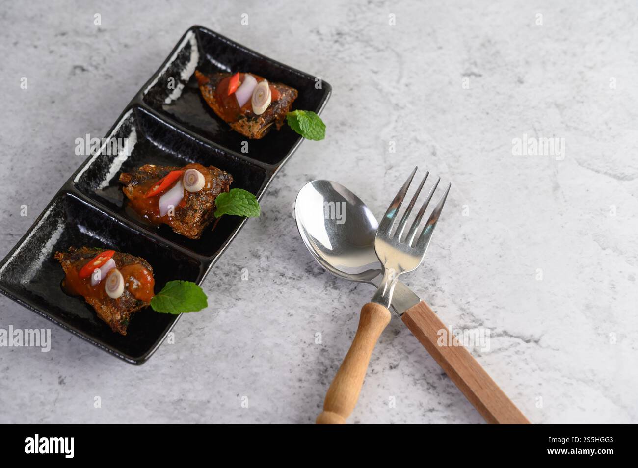 Top view with Appetizers with the spicy sardine in ceramic tray, spoon ...