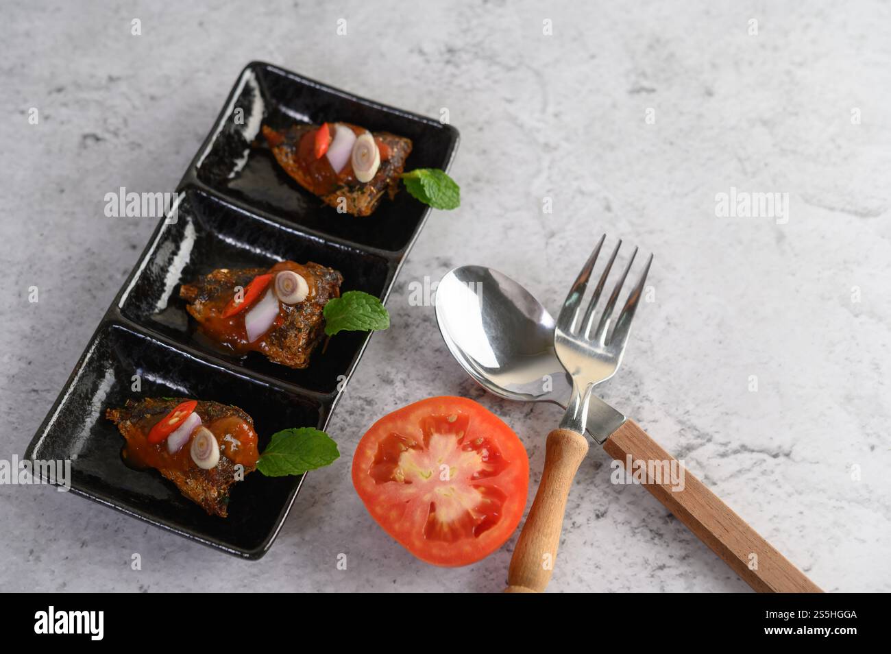 Top view with Appetizers with the spicy sardine in ceramic tray, spoon ...