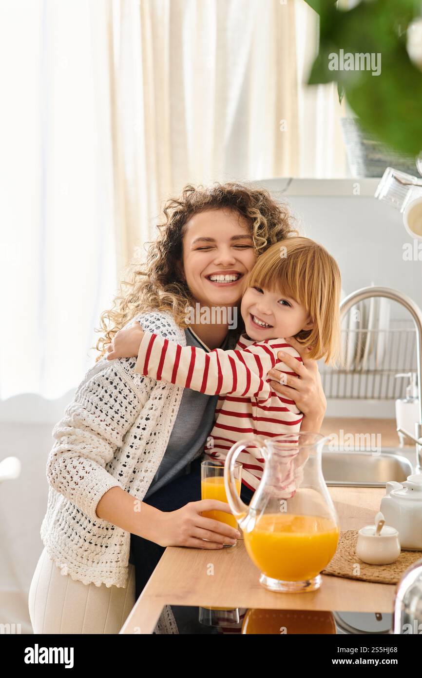 Curly-haired mom and daughter joyfully make refreshing drinks in their ...