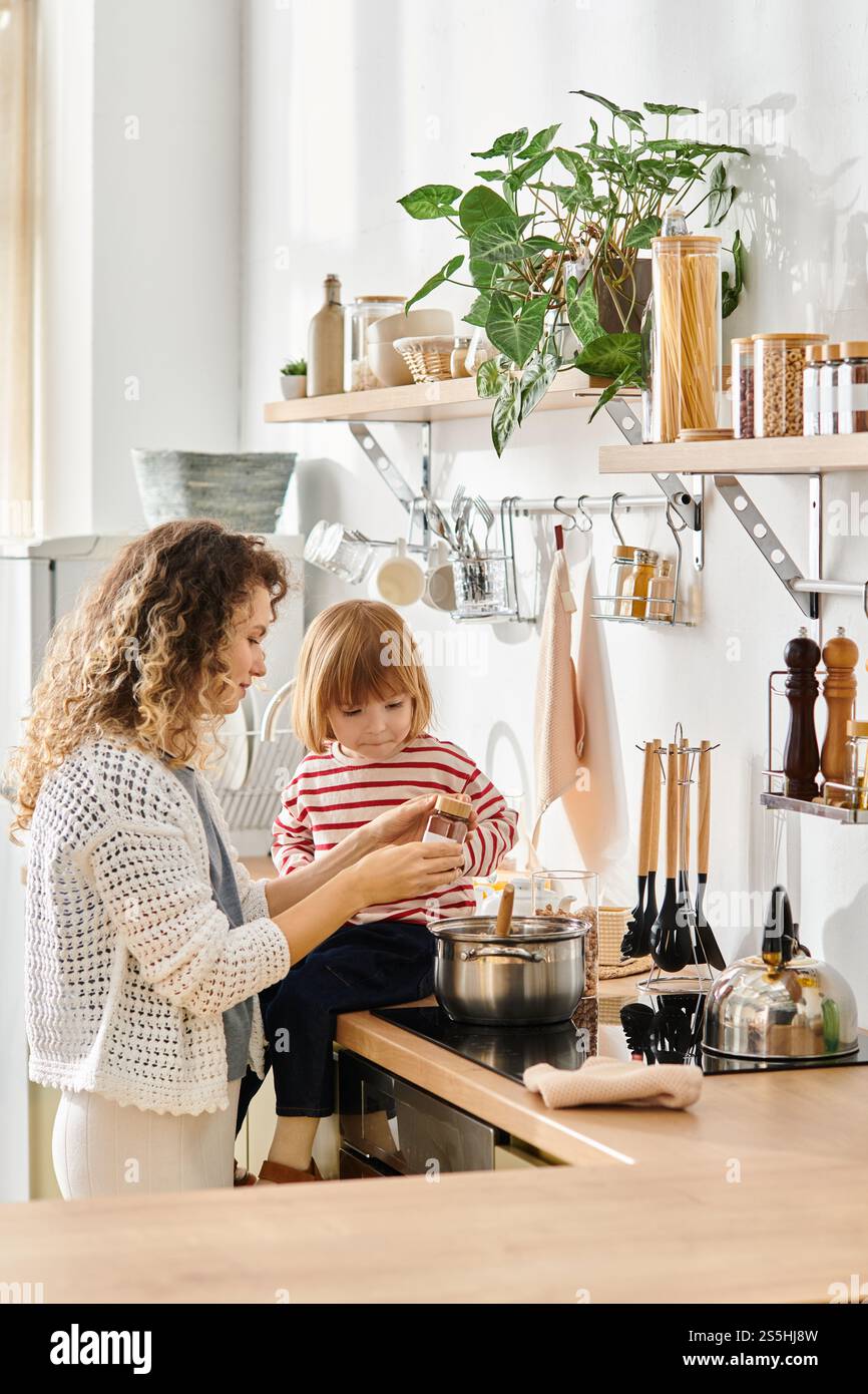 A mother and daughter bond while having fun cooking in a bright ...