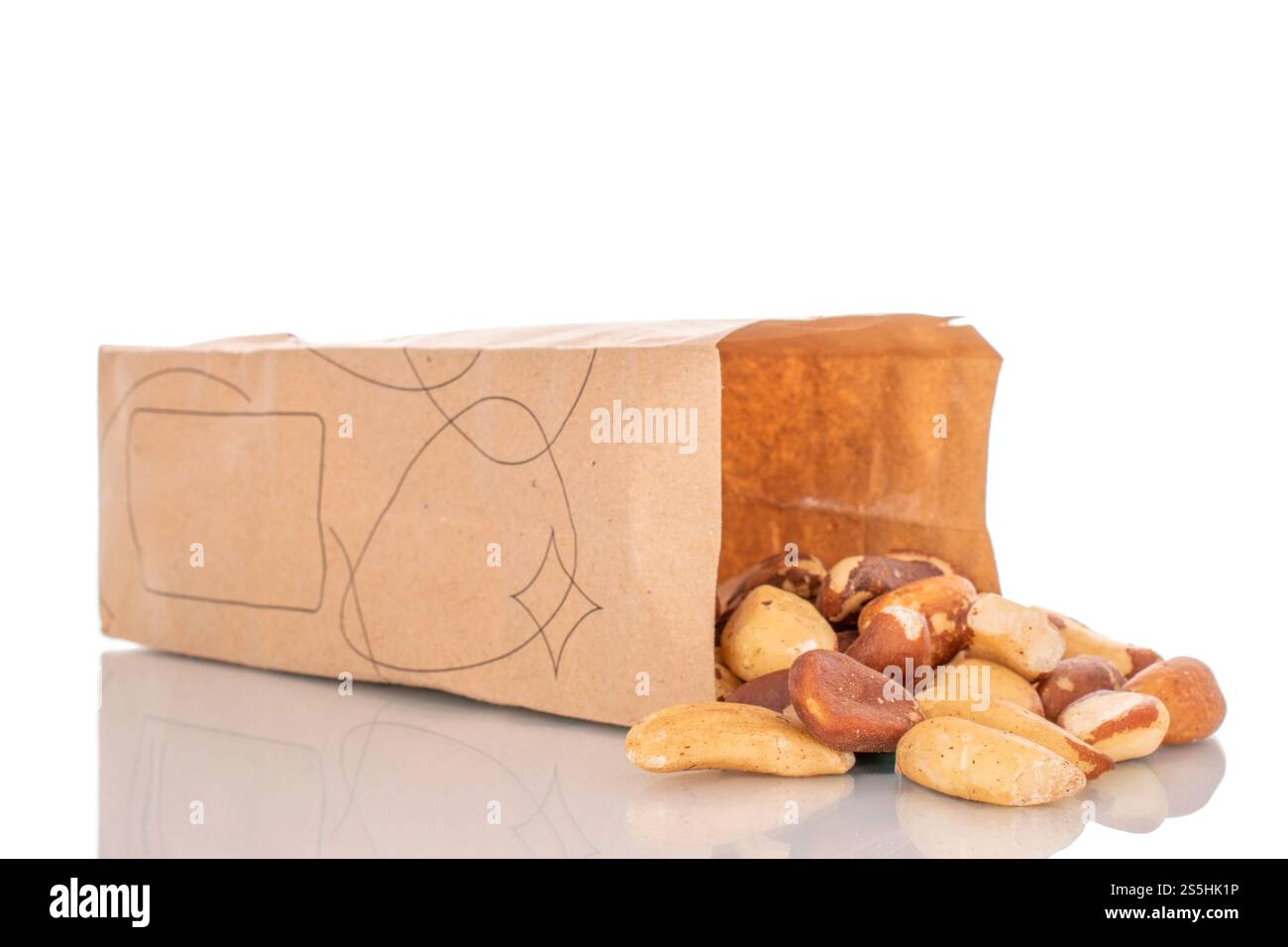 Brazil nuts without shells with paper bag, close-up, isolated on white ...