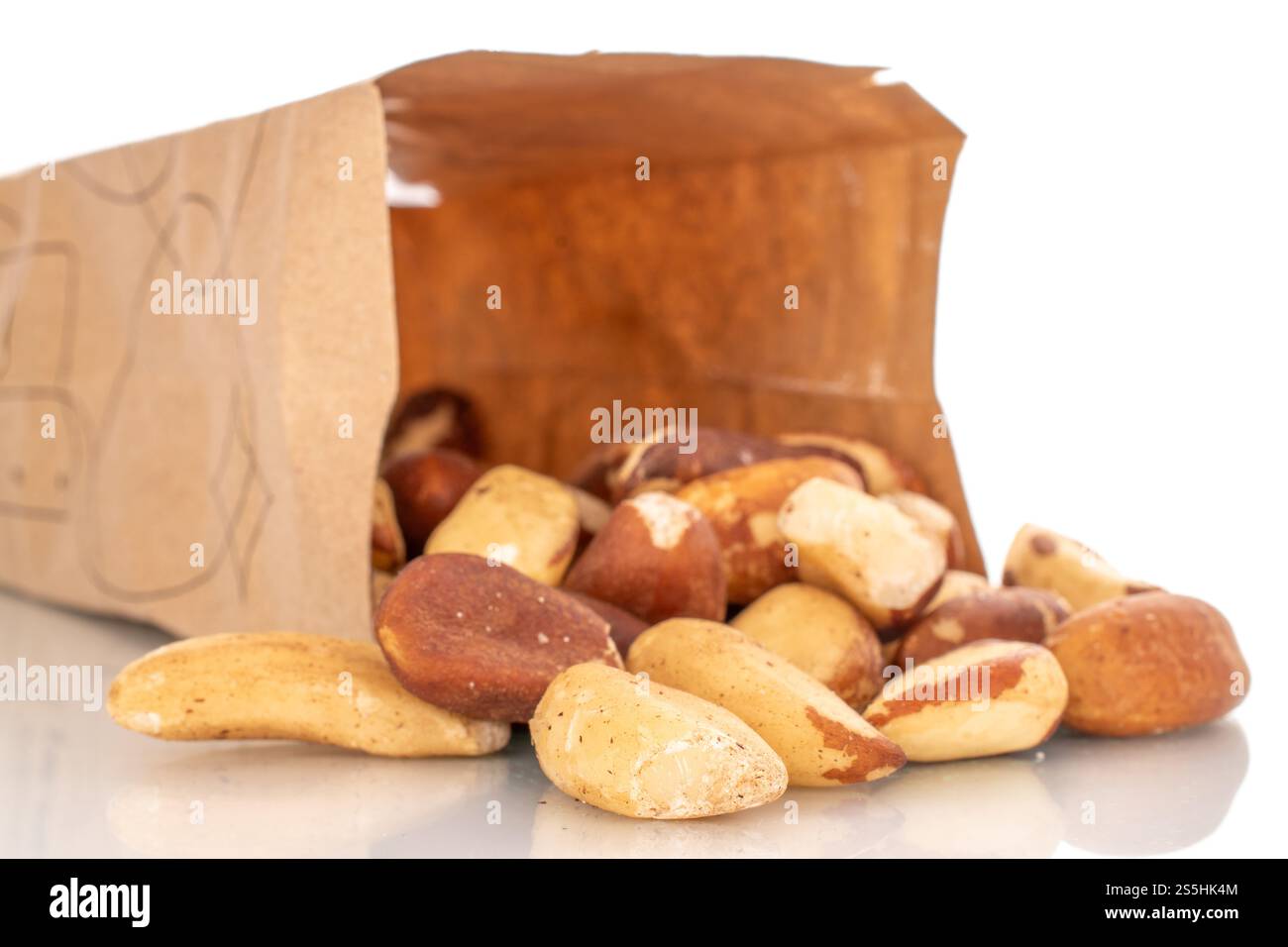 Brazil nuts without shells with paper bag, close-up, isolated on white ...