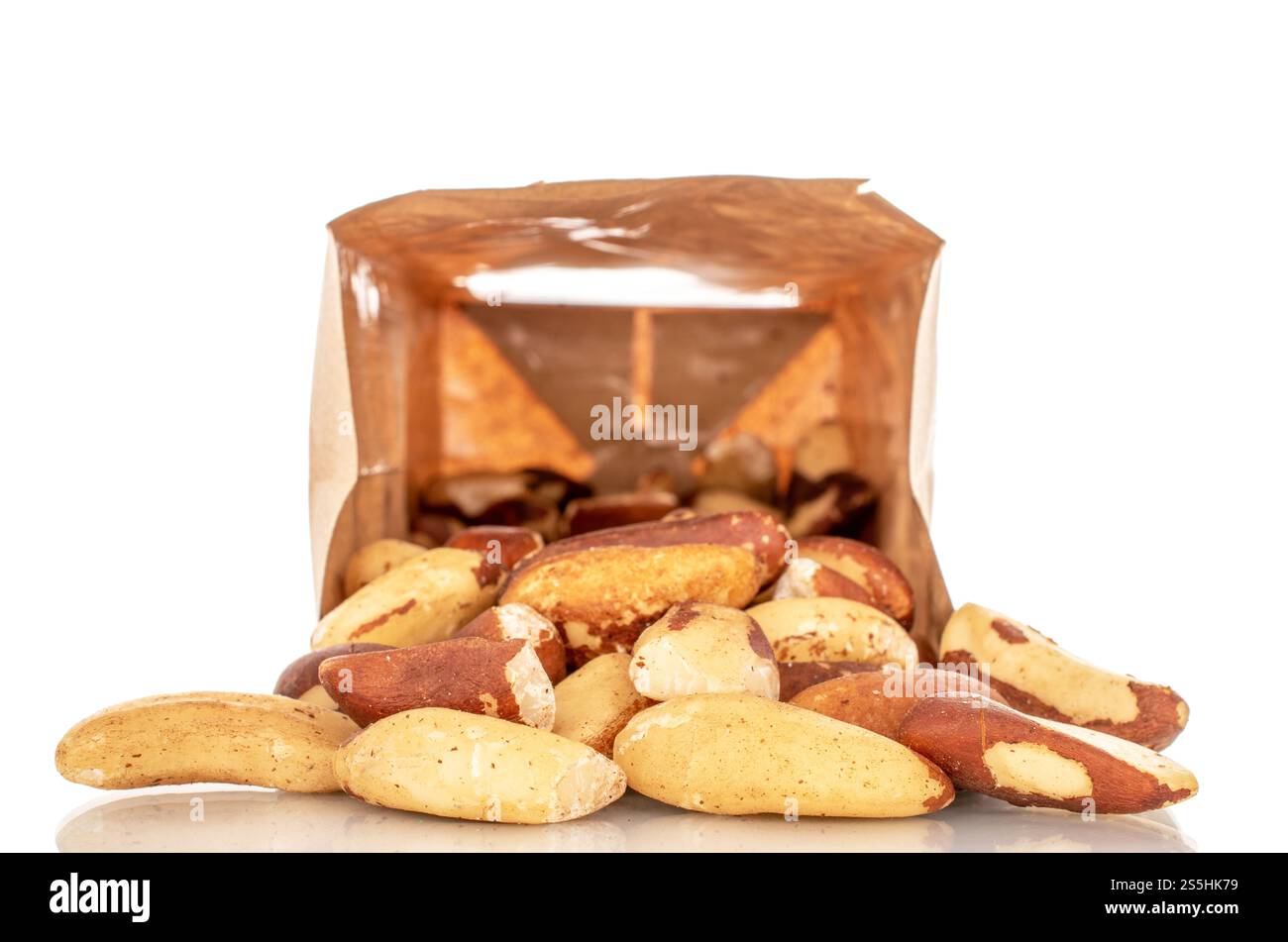 Brazil nuts without shells with paper bag, close-up, isolated on white ...