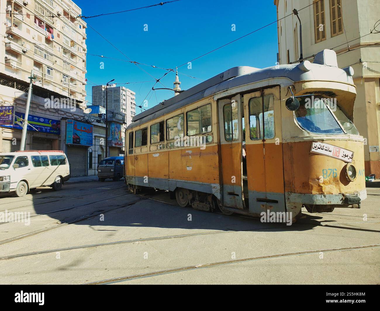 A Vintage Tram car running on electric lines through the busy streets ...