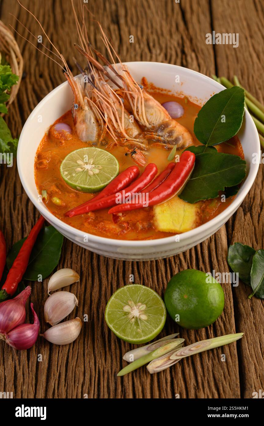 Tom Yum Kung Thai hot spicy soup shrimp with lemon grass,lemon,galangal and chilli on wooden ...