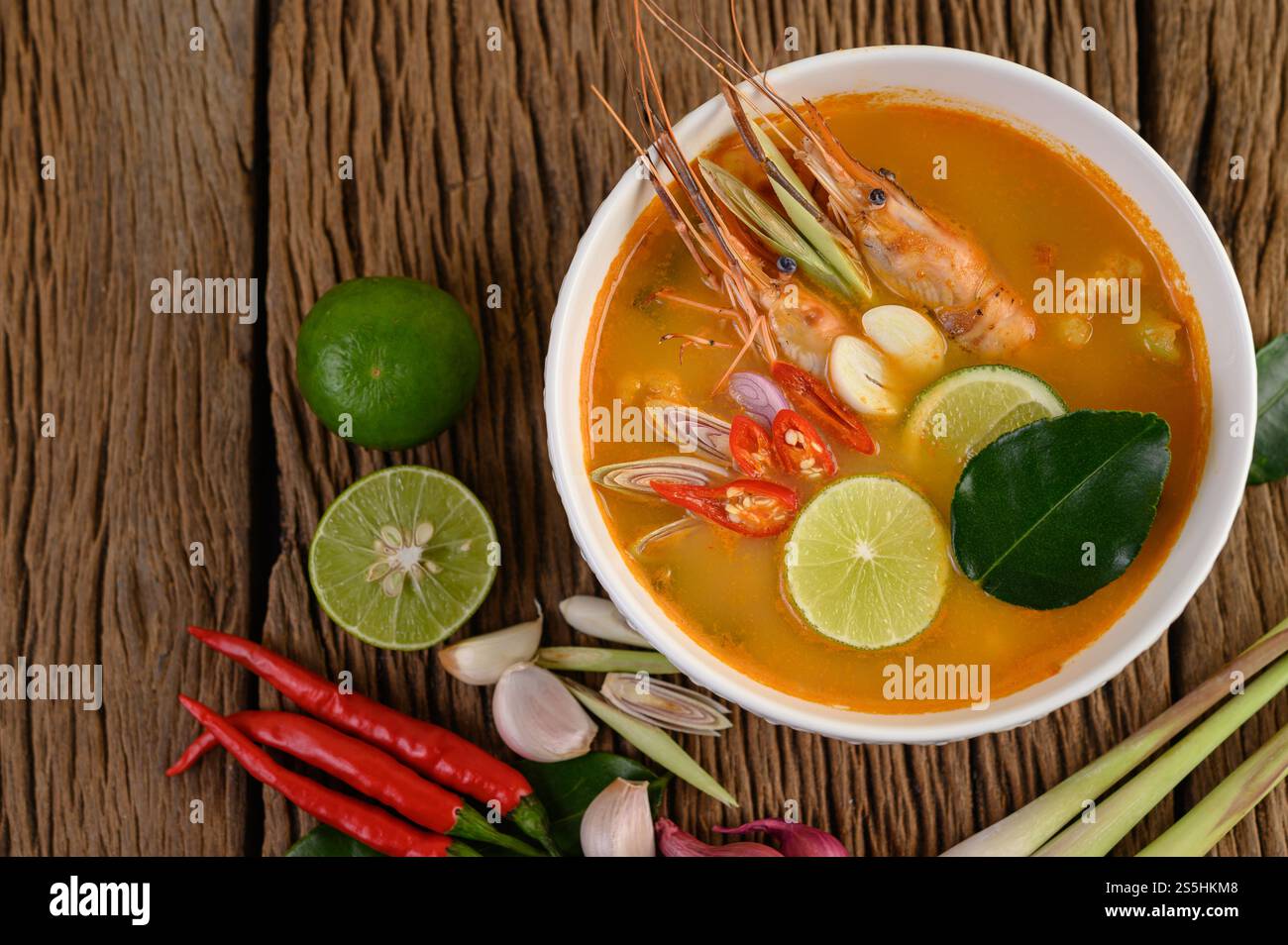 Tom Yum Kung Thai hot spicy soup shrimp with lemon grass,lemon,galangal and chilli on wooden ...