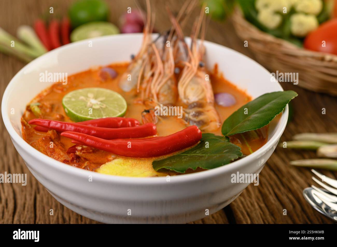 Tom Yum Kung Thai hot spicy soup shrimp with lemon grass,lemon,galangal and chilli on wooden ...