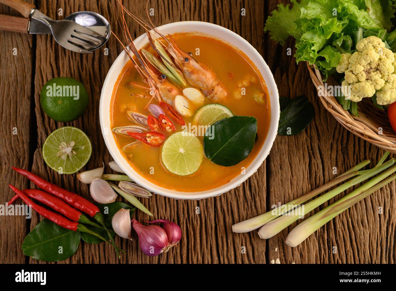 Tom Yum Kung Thai hot spicy soup shrimp with lemon grass,lemon,galangal and chilli on wooden ...
