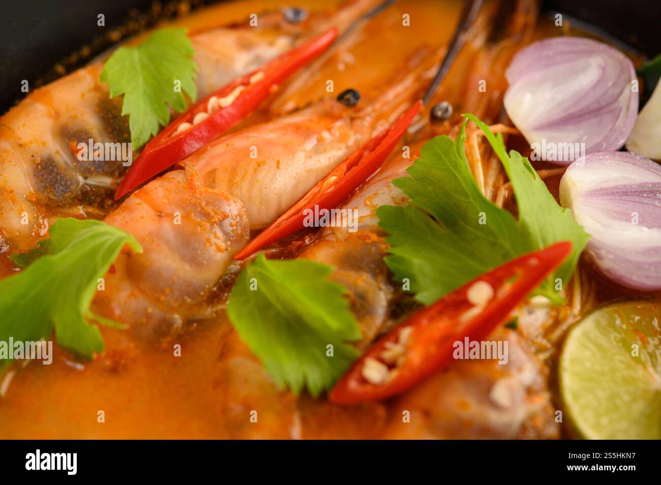 Tom Yum Kung Thai hot spicy soup shrimp with lemon grass,lemon,galangal and chilli on wooden ...