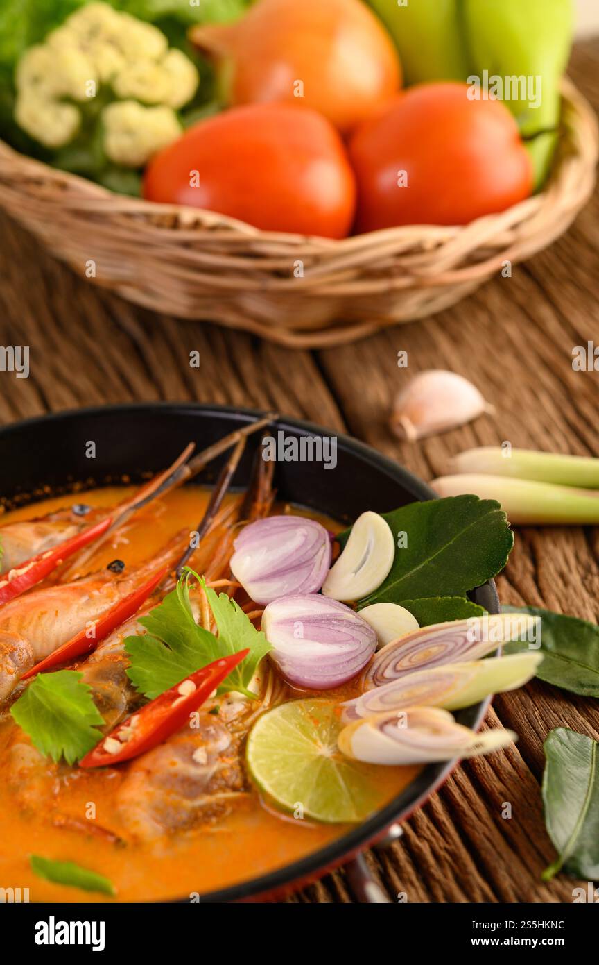Tom Yum Kung Thai hot spicy soup shrimp with lemon grass,lemon,galangal and chilli on wooden ...