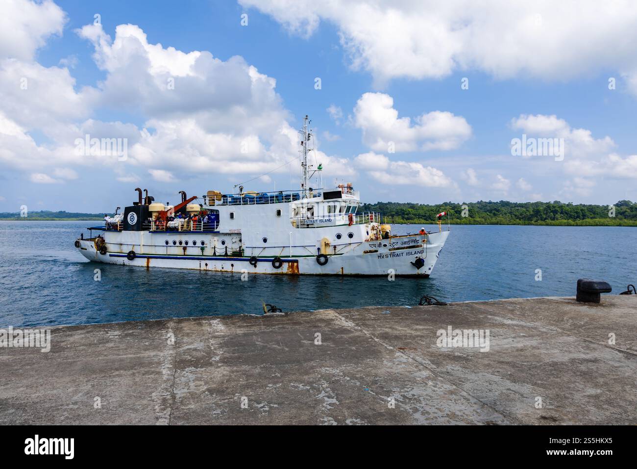 government passenger ship ferry docking at island jetty under clear ...