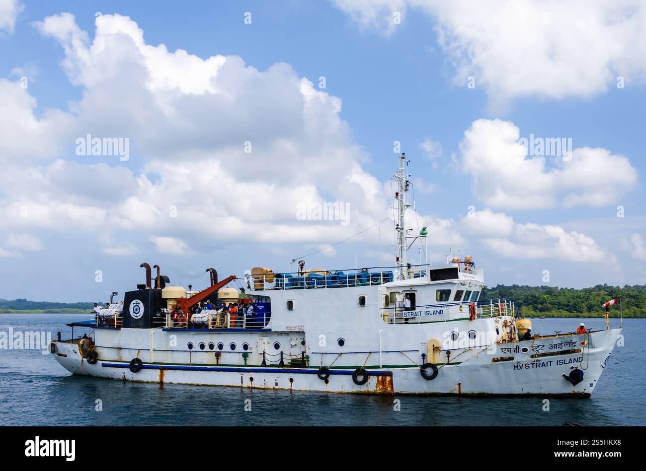 government passenger ship ferry docking at island jetty under clear ...