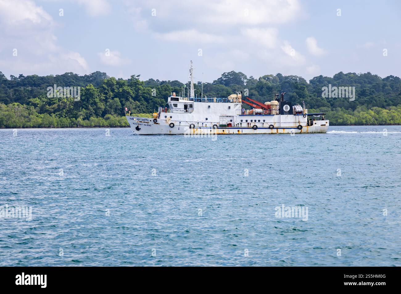 passenger ship sailing along island shoreline with vibrant morning sky ...