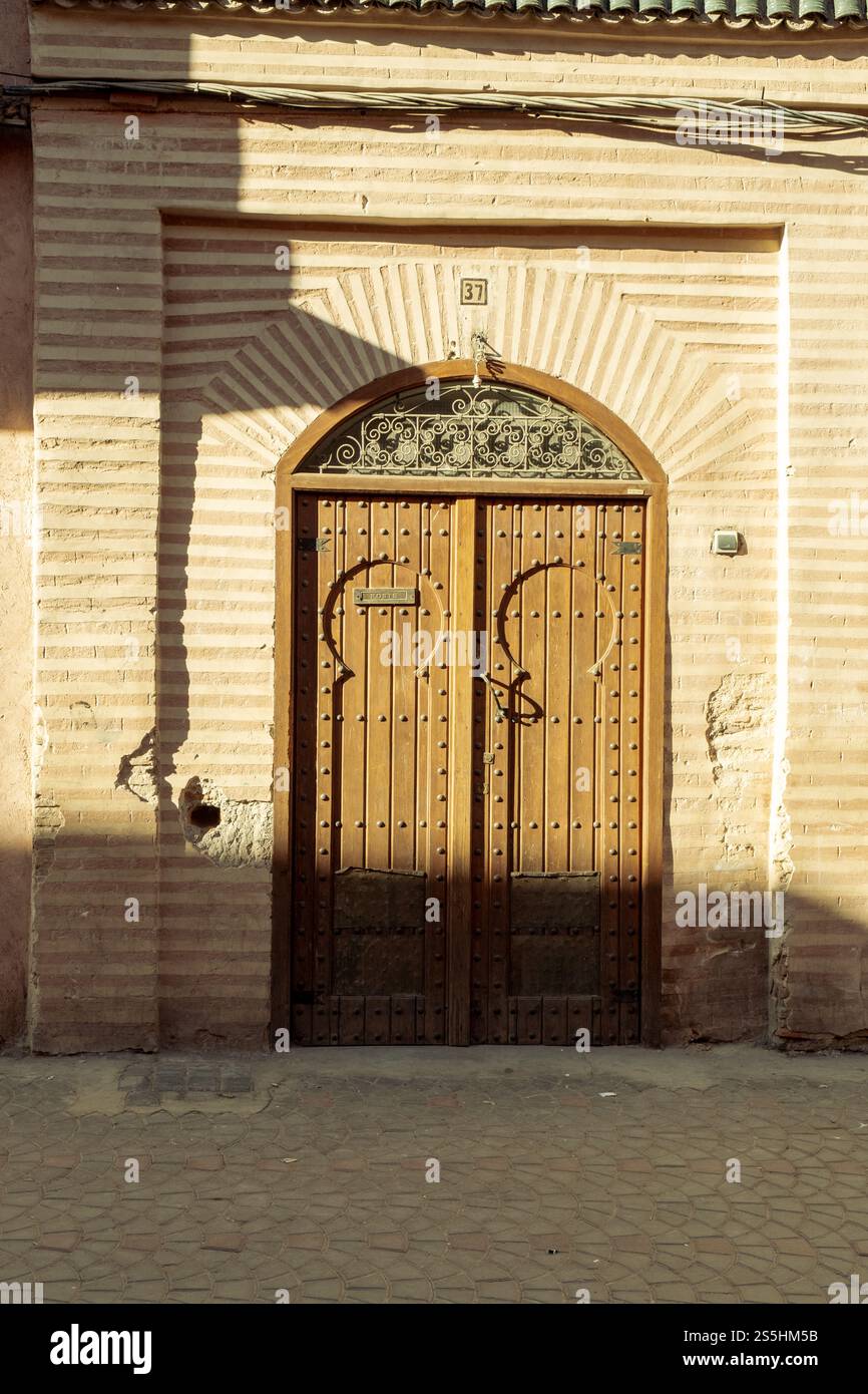 Traditional arabic design wooden entrance doors in the Marrakech Medina ...