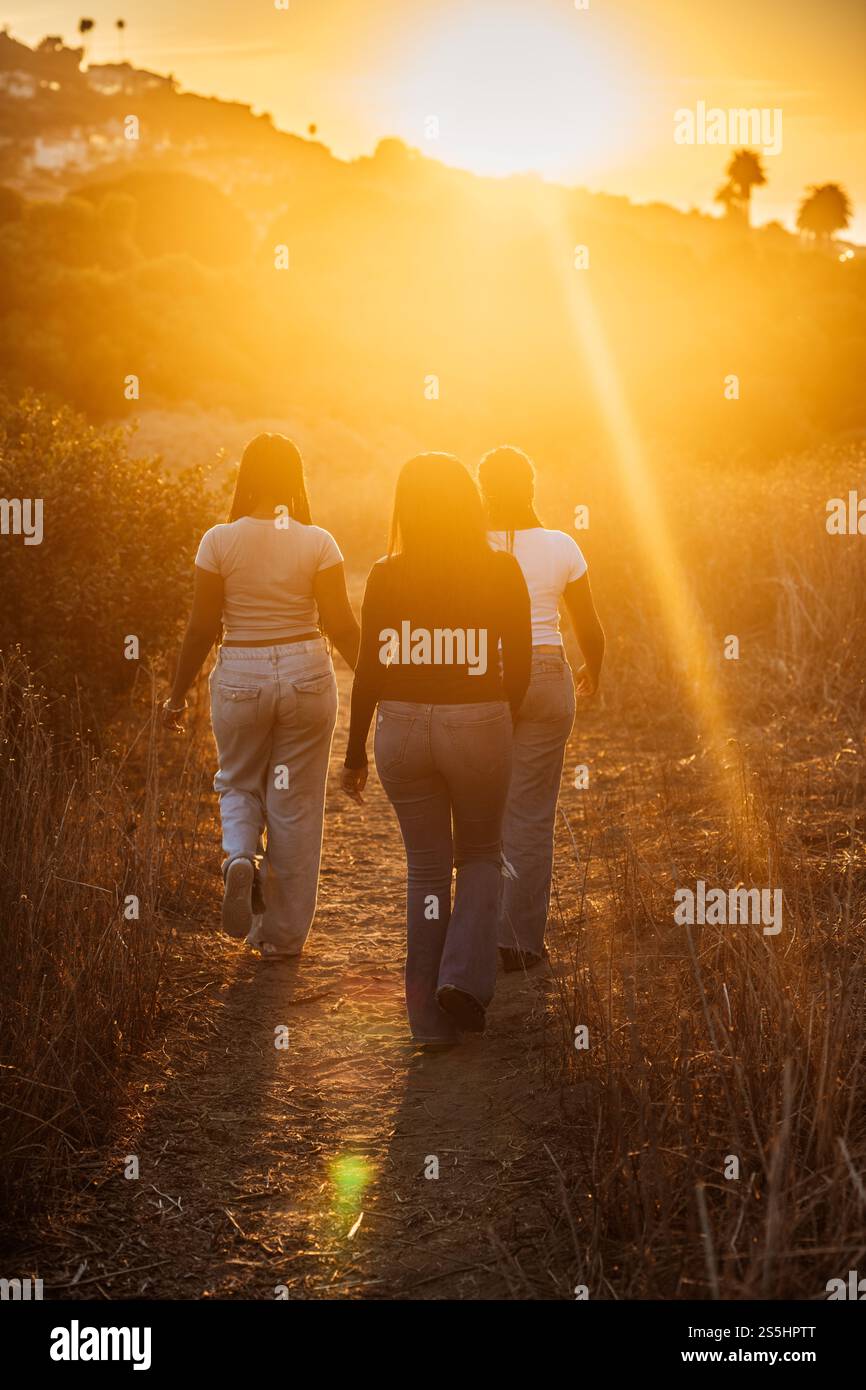 3 sisters hiking together at sunset hi-res stock photography and images ...