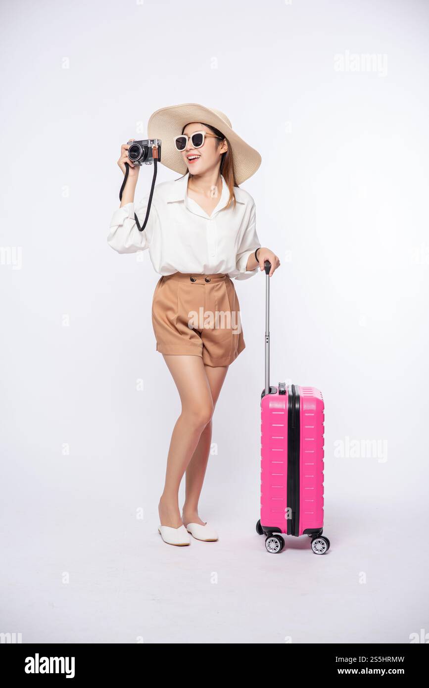 Women wear hats, glasses, luggage, and carry cameras on the way to travel Stock Photo - Alamy