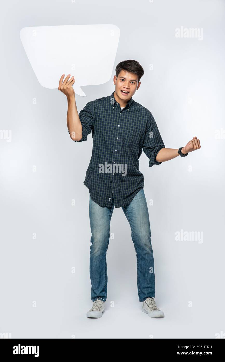 A man in a black shirt holds a thought box symbol Stock Photo - Alamy