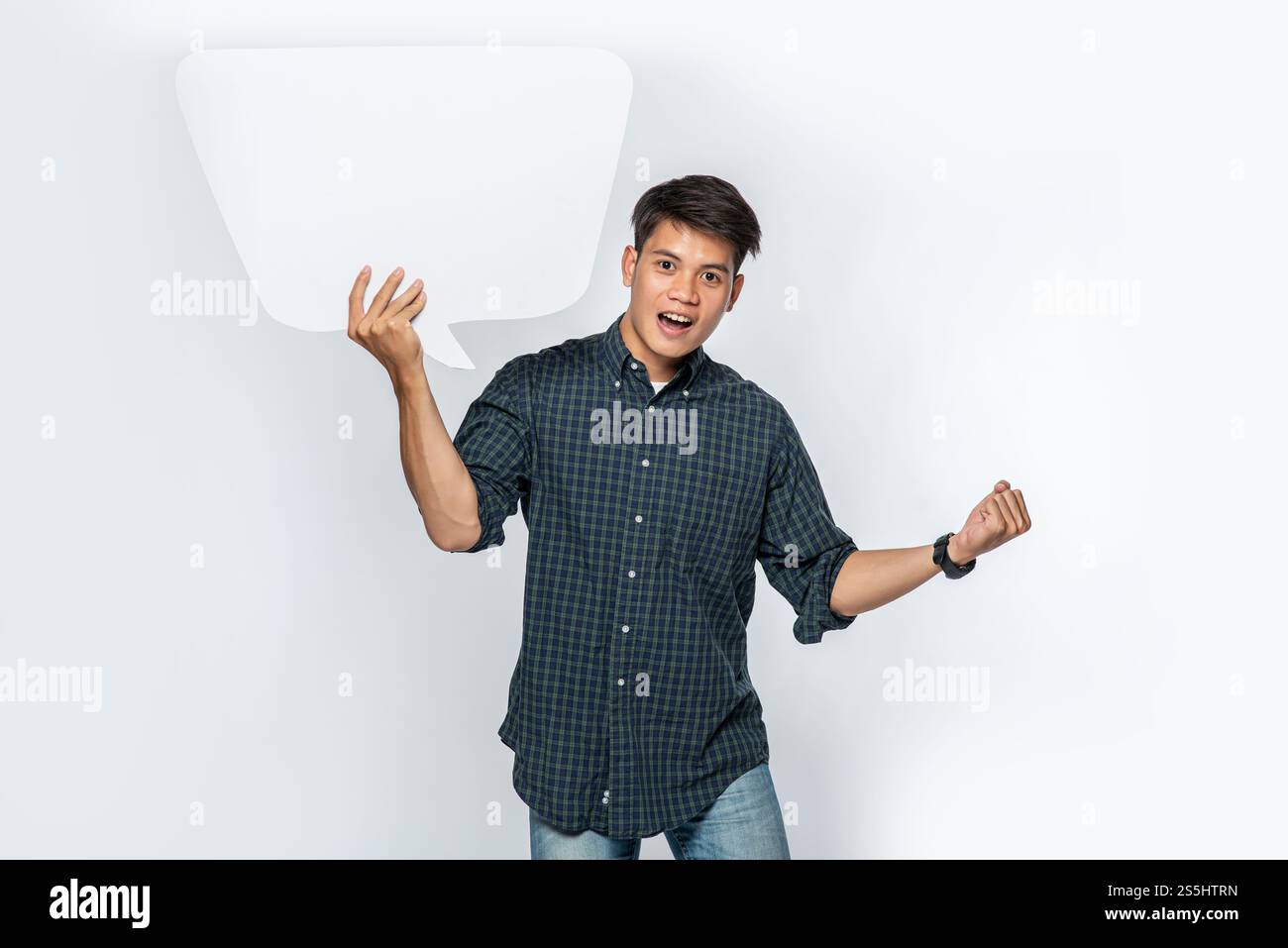 A man in a black shirt holds a thought box symbol Stock Photo - Alamy