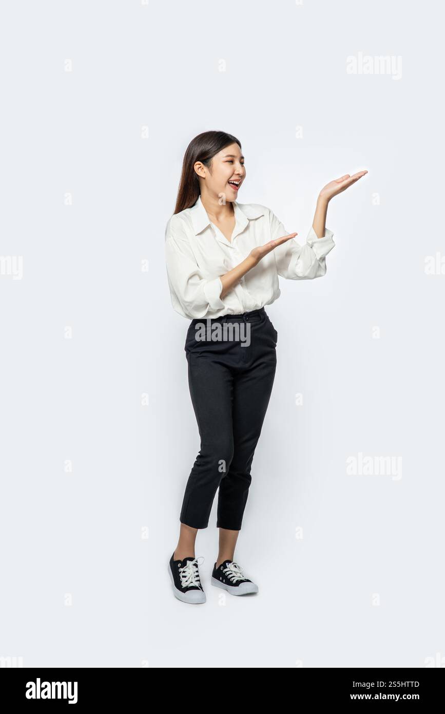 The girl in a white shirt and the open hand sign on the left Stock ...