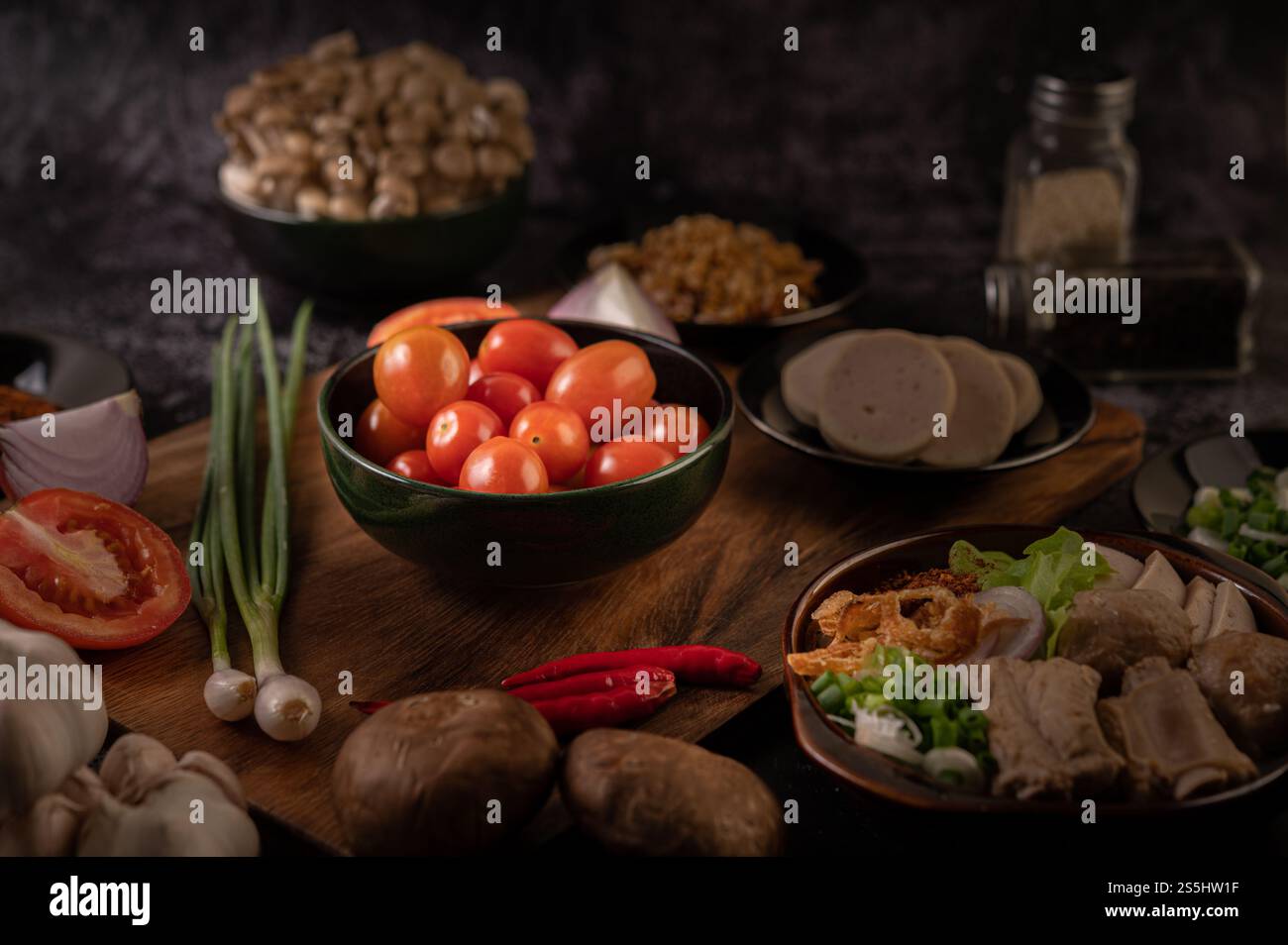 The tomatoes in the black cup with spring onions hi-res stock ...