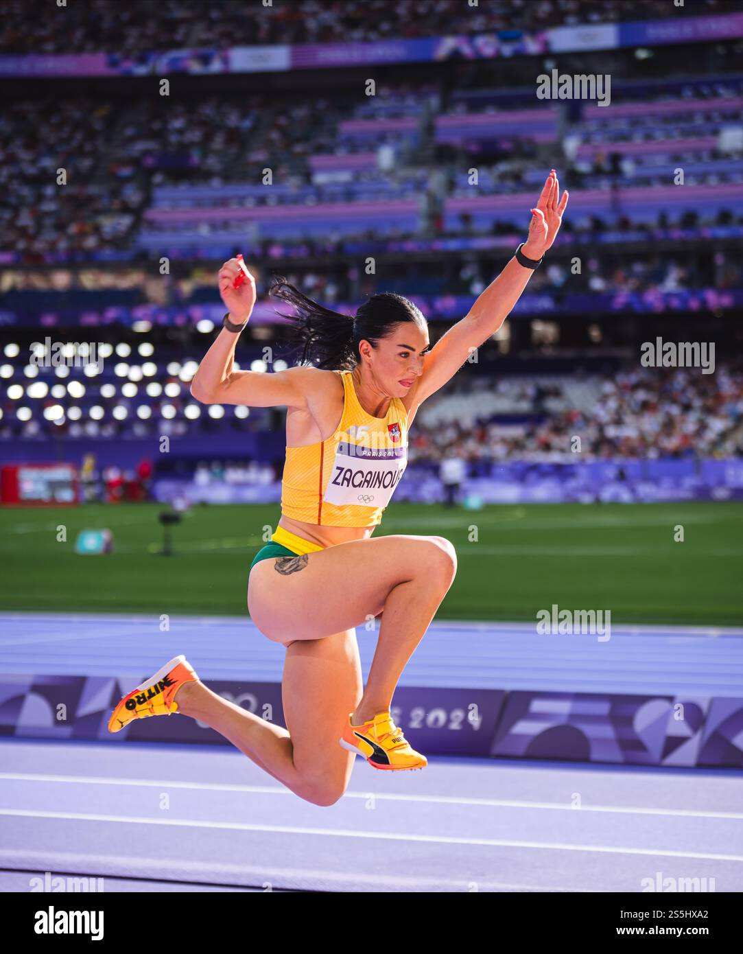 Diana Zagainova celebrating her medal with her country's flag at the ...
