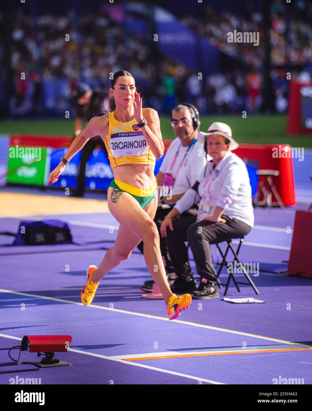 Diana Zagainova celebrating her medal with her country's flag at the ...