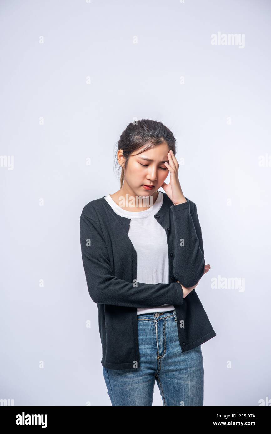 A sick woman with a headache and put her hand on her head Stock Photo ...