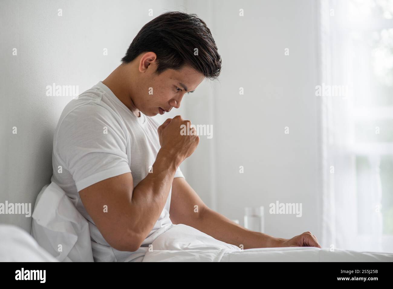 The man coughed and put his hand over his mouth and sat down on the bed ...