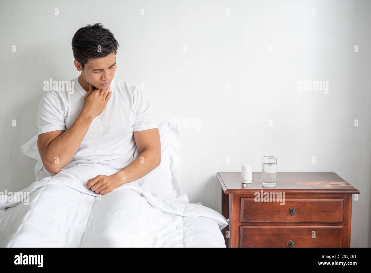 The man coughed and put his hand over his mouth and sat down on the bed ...