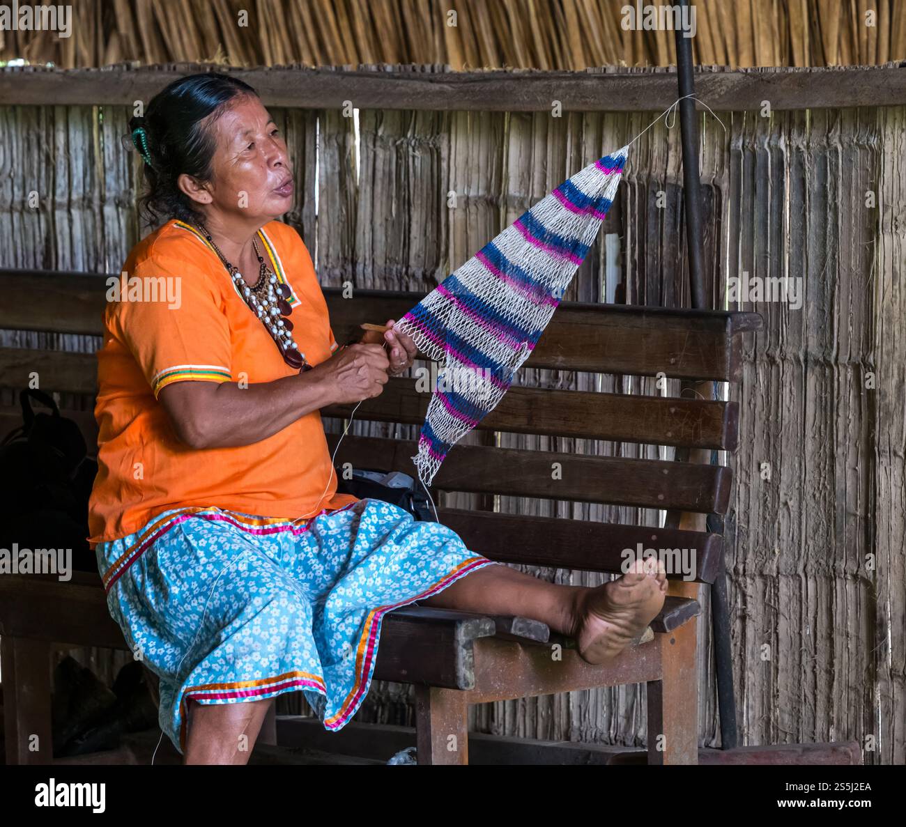 Woman from Añangu Kichwa community weaving, Amazon rainforest, Yasuni National Park, Ecuador ...