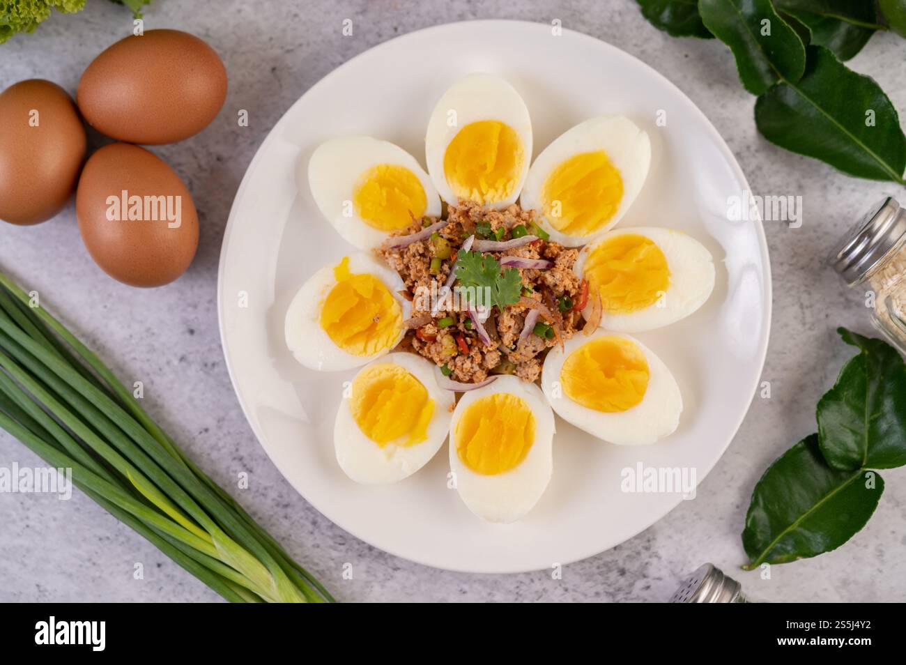 Half boiled egg and Pork Larb on a plate Stock Photo - Alamy