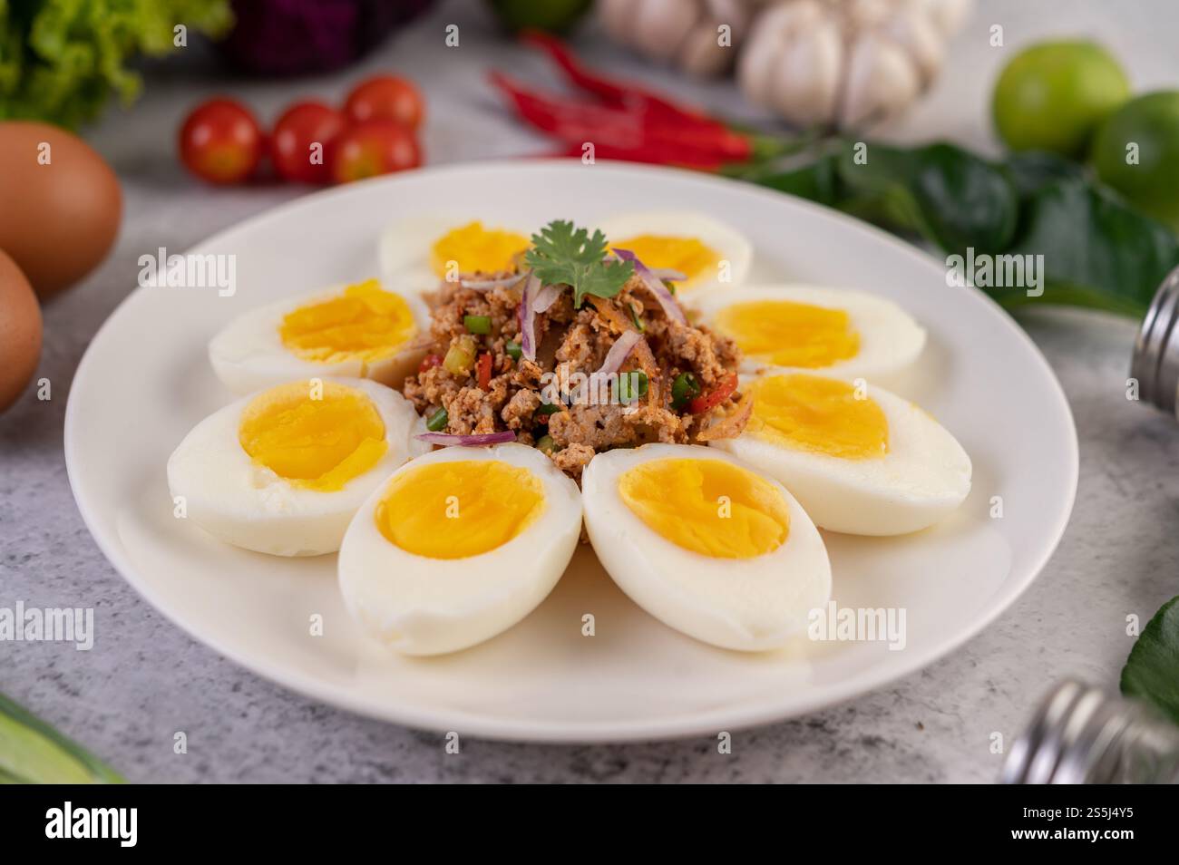 Half boiled egg and Pork Larb on a plate Stock Photo - Alamy