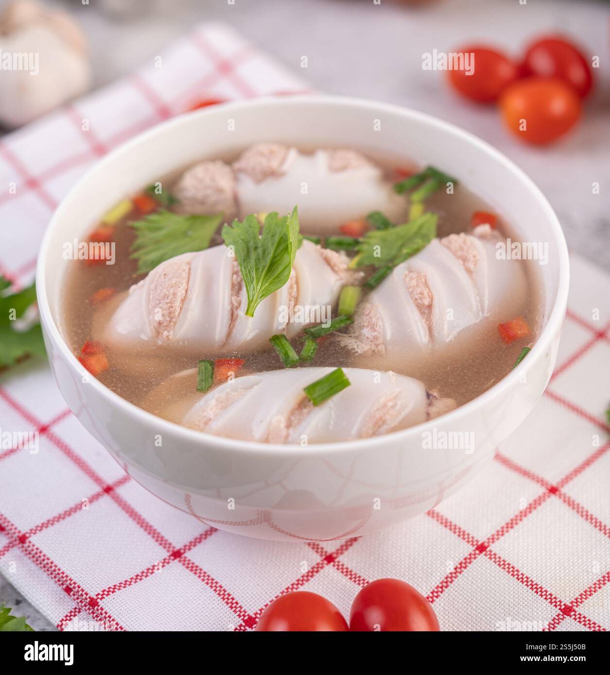 Squid soup stuffed with pork, sprinkled with coriander and chopped ...