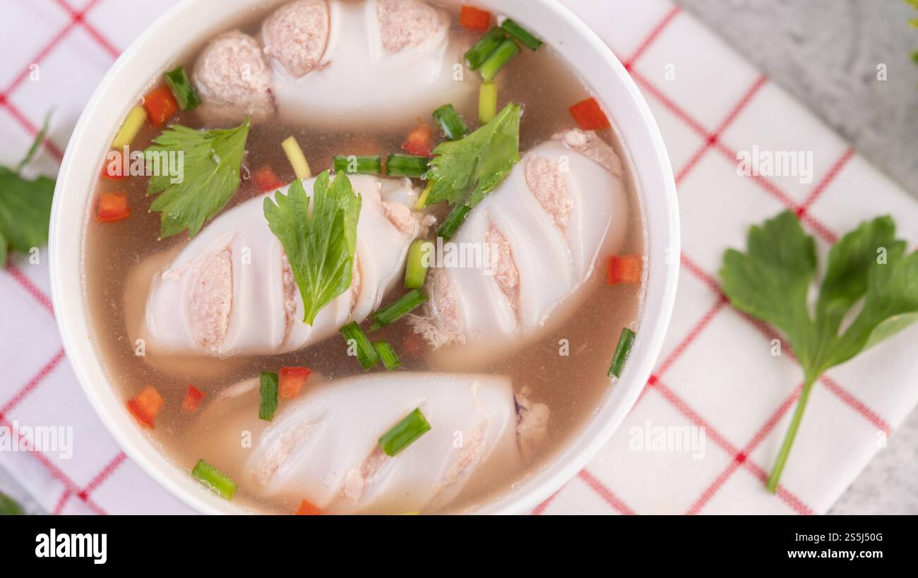 Squid soup stuffed with pork, sprinkled with coriander and chopped ...