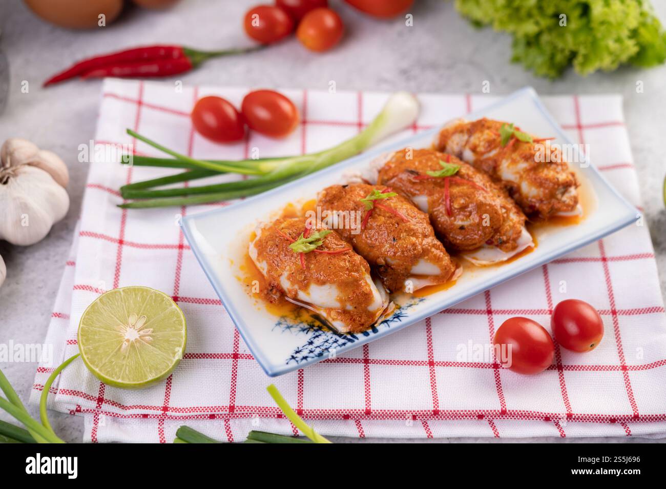 Chu che squid with spring onion, tomato, lemon and chili Stock Photo ...