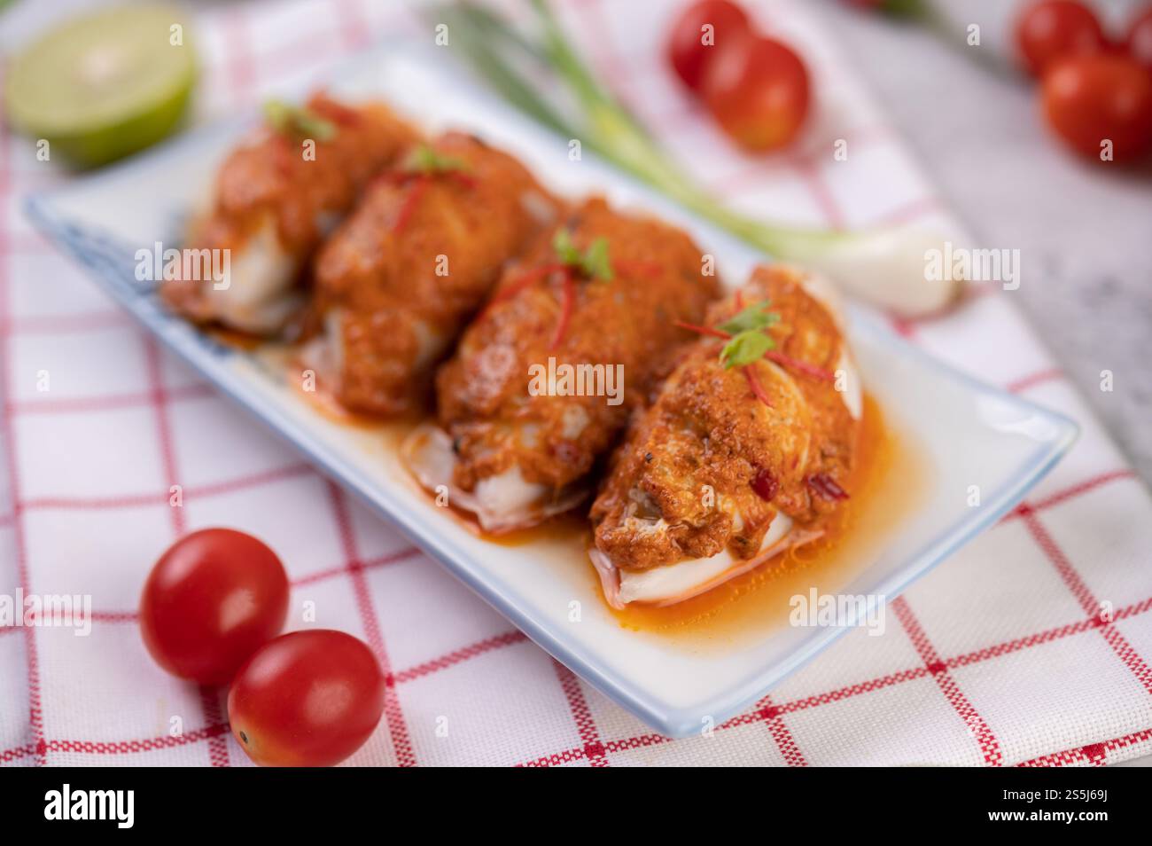 Chu che squid with spring onion, tomato, lemon and chili Stock Photo ...