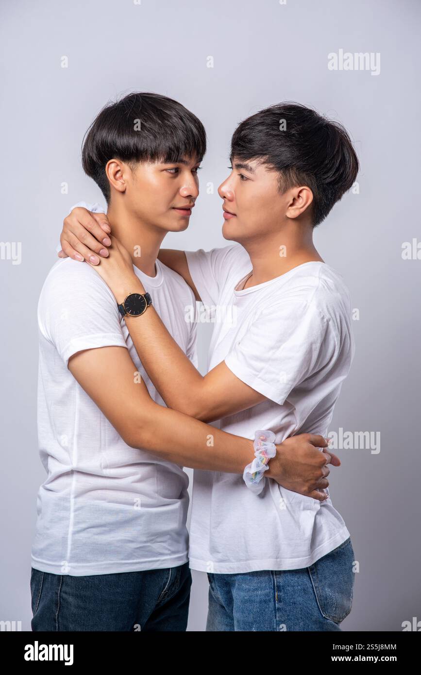 Two men who love each other happily hug each other Stock Photo - Alamy