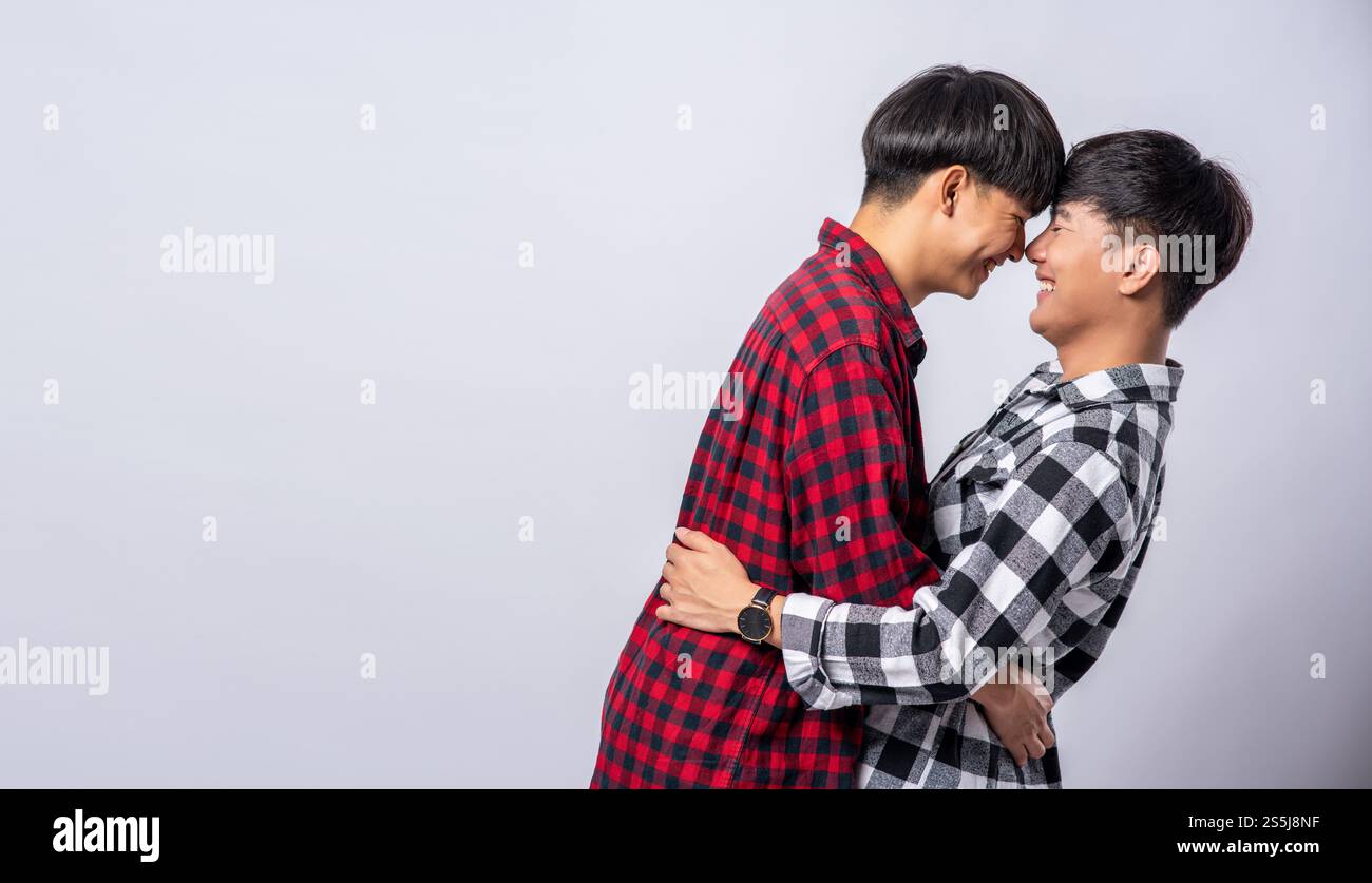 Two men who love each other happily hug each other Stock Photo - Alamy
