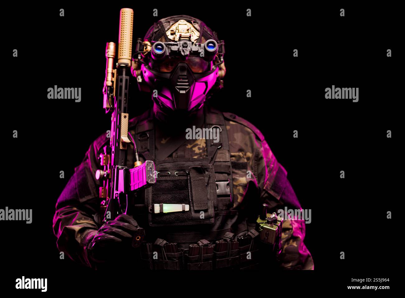 A heavily equipped tactical soldier in high-tech gear and armor posed ...