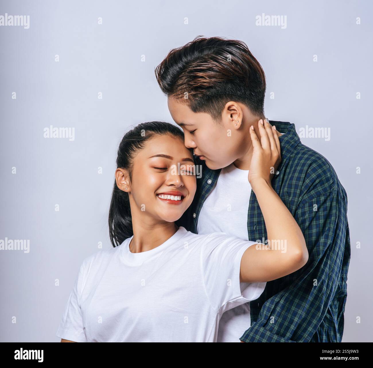 Two female lovers standing and hugging from behind Stock Photo - Alamy