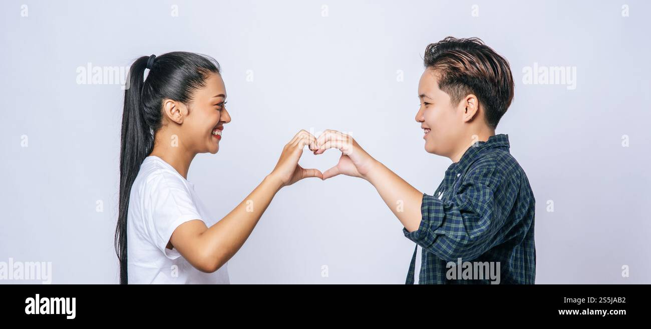 Two young women love each other hand mark heart shape Stock Photo - Alamy