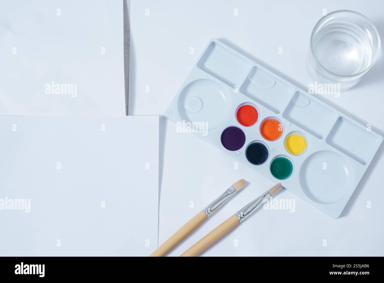 Paintbrush tray and watercolors for coloring Stock Photo - Alamy