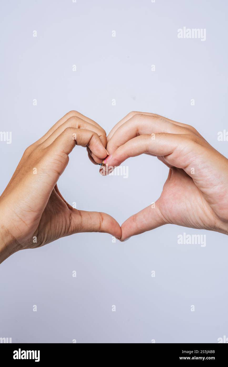 Two young women love each other hand mark heart shape Stock Photo - Alamy