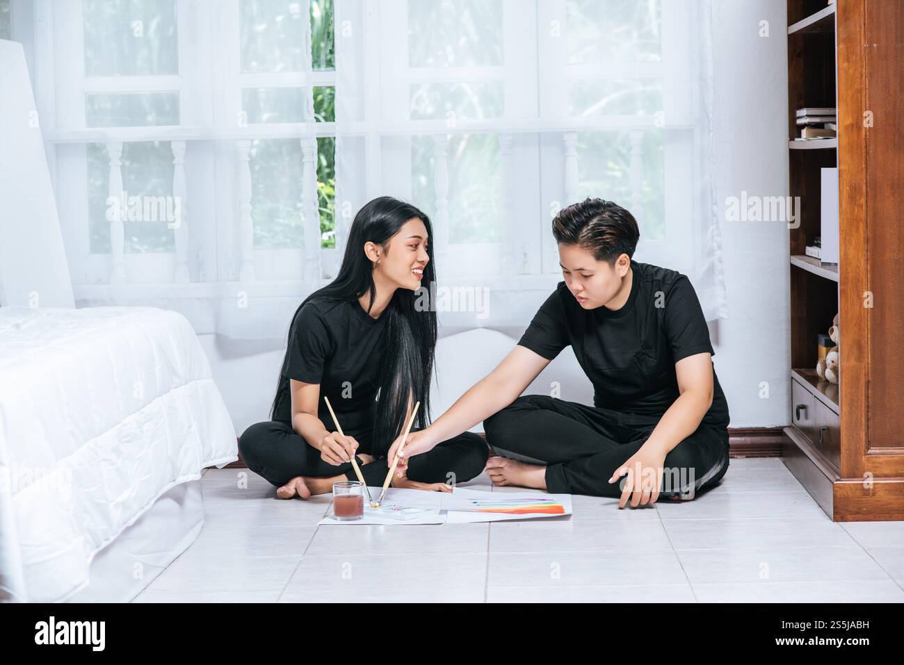 Female couples draw and paint on paper Stock Photo - Alamy