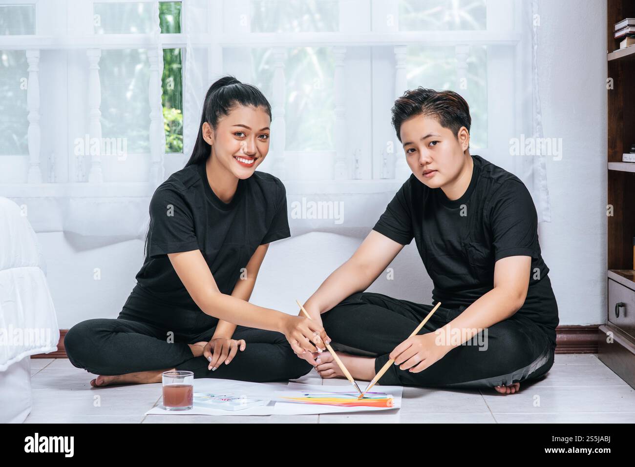 Female couples draw and paint on paper Stock Photo - Alamy