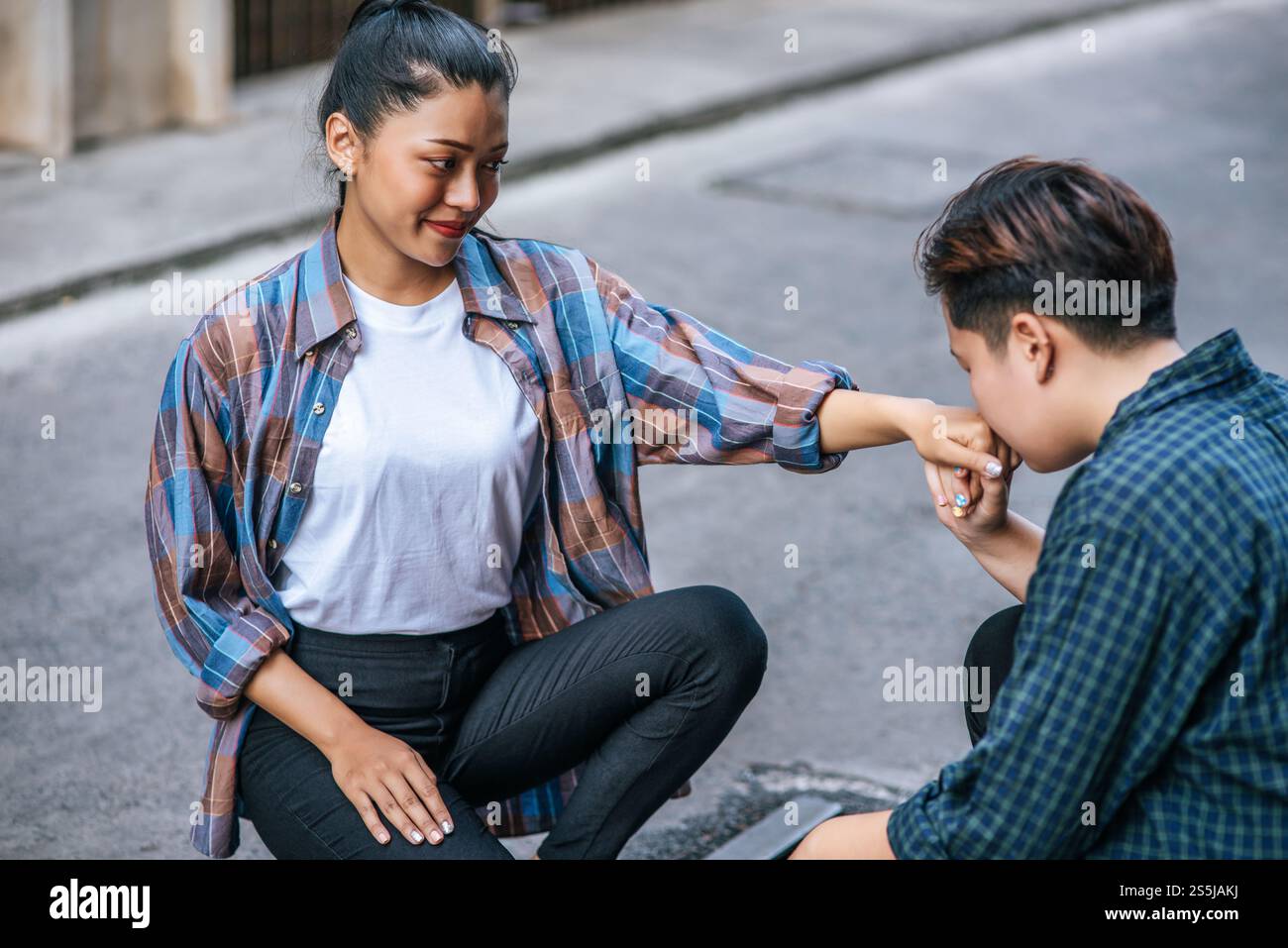 The woman of two lovers sat and kissed the hand of one another Stock ...