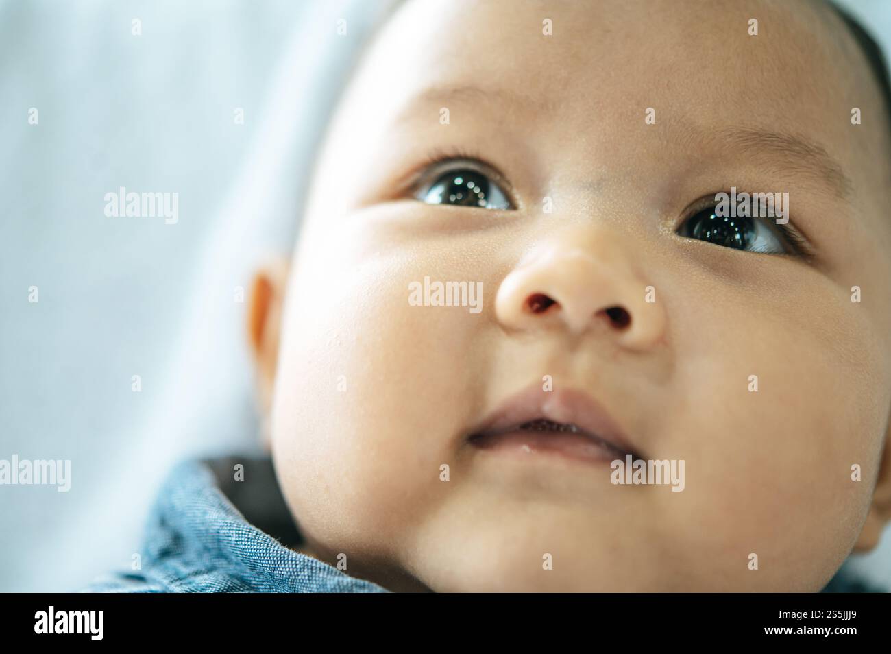 A newborn baby who opens his eyes and looks forward Stock Photo - Alamy
